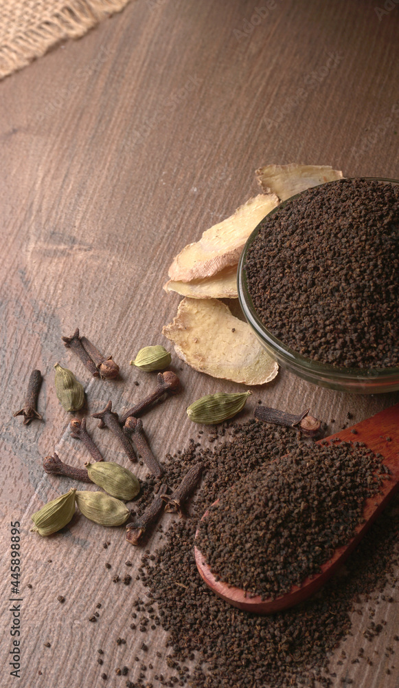 Black Tea Powder or dry dust tea powder, chai patti isolated in wooden ...