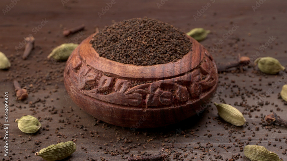Black Tea Powder or dry dust tea powder, chai patti isolated in wooden ...