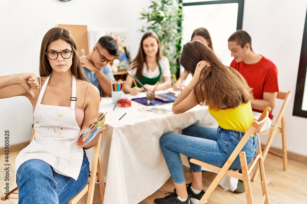 Young artist woman drawing at art studio with angry face, negative sign ...