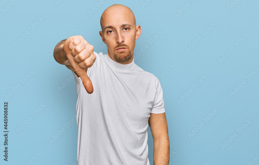 Bald man with beard wearing casual white t shirt looking unhappy and ...