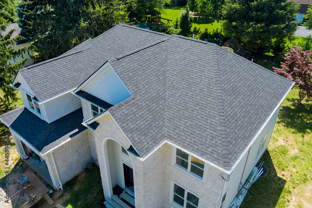 Aerial view of asphalt shingles roofing construction, the house with ...