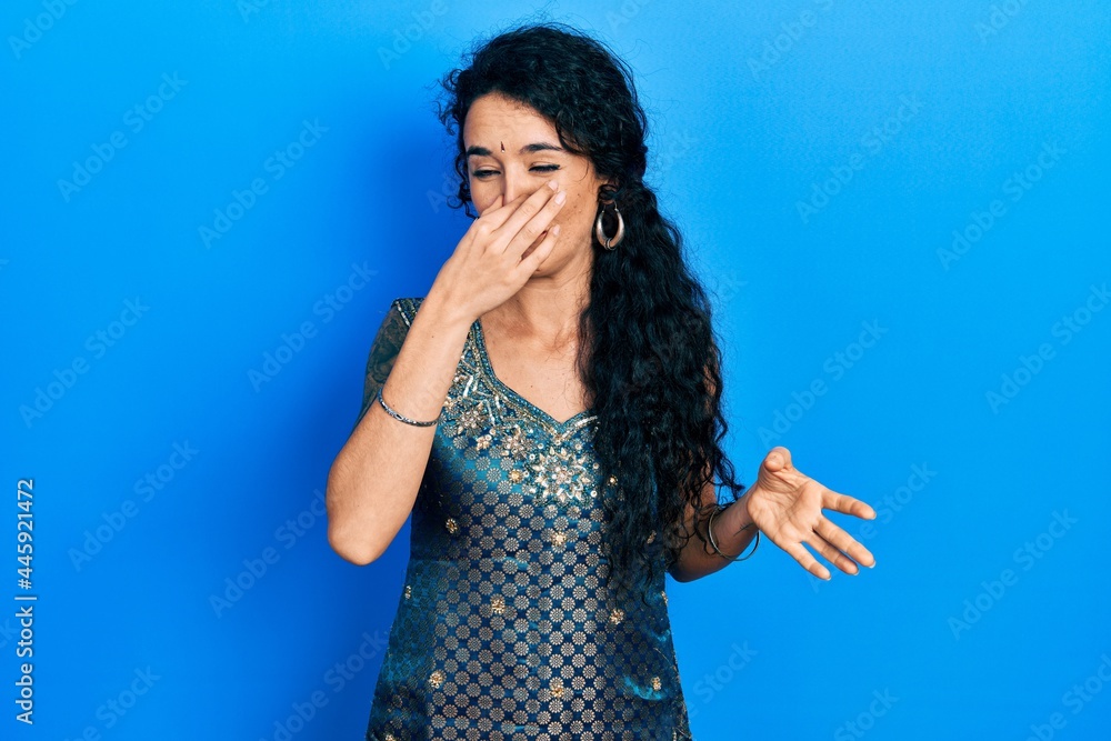 Young woman wearing bindi and traditional kurta dress smelling ...