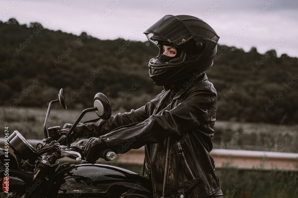 Portrait of confident motorcyclist woman in motorcycle helmet. Young ...
