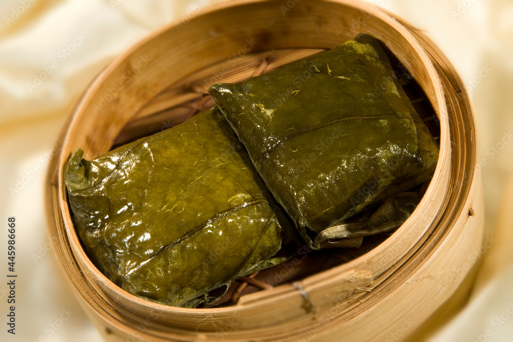 steamed sticky glutinous rice and meat wrapped in lotus leaf bamboo ...