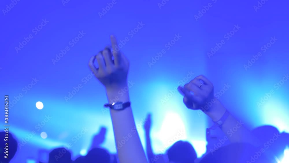 Slow motion: teenage girl partying, dancing and waving hands at rock ...