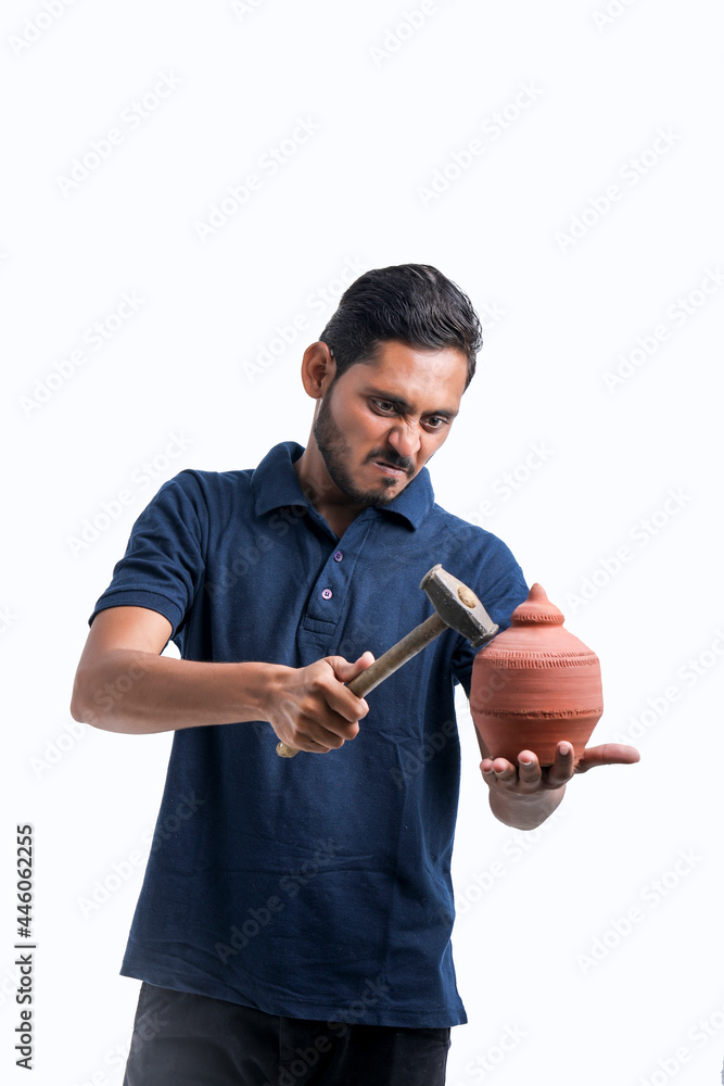 Indian man using hammer for broken clay piggy bank. Stock Photo | Adobe ...