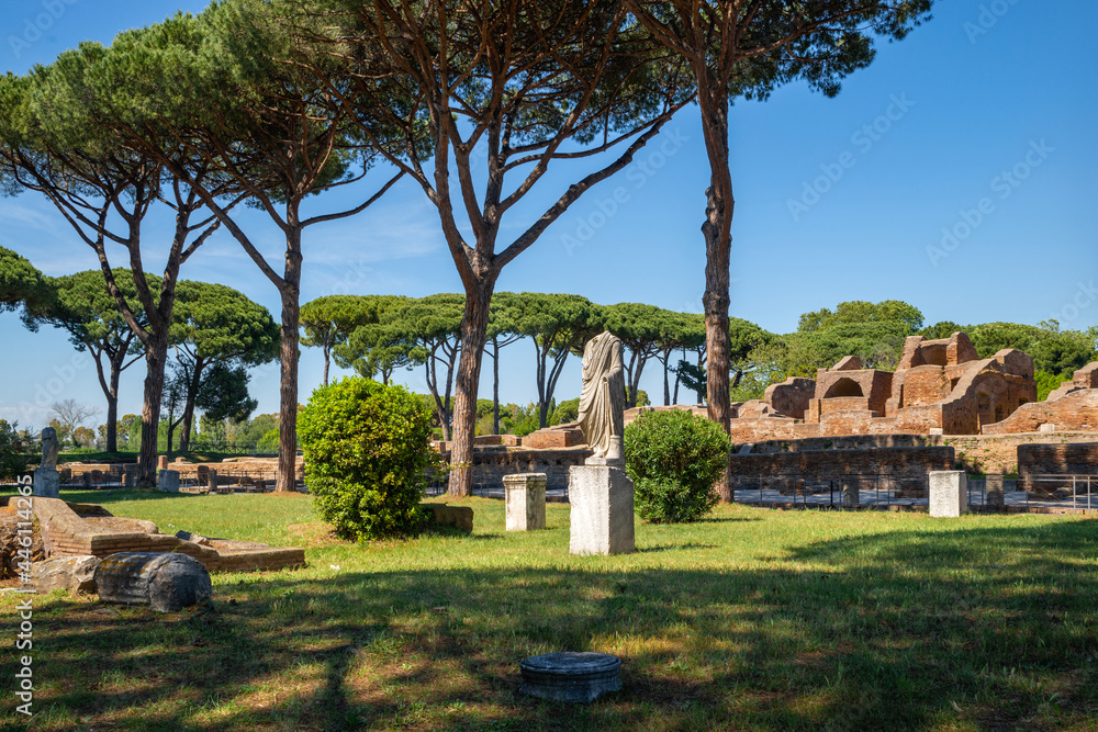 Panorama of the excavations of Ostia Antica, Rome Italy. Statue toga in ...