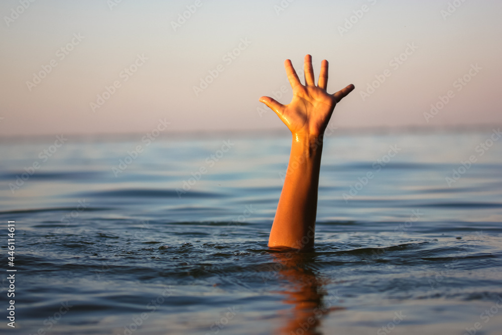 A man is drowning in water. A hand peeks out from under a water. A ...