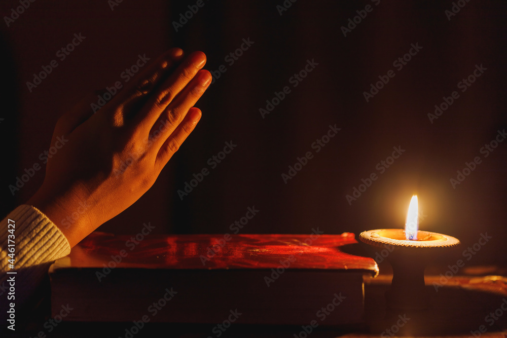 Praying hands with faith in religion and belief in God with lighting ...