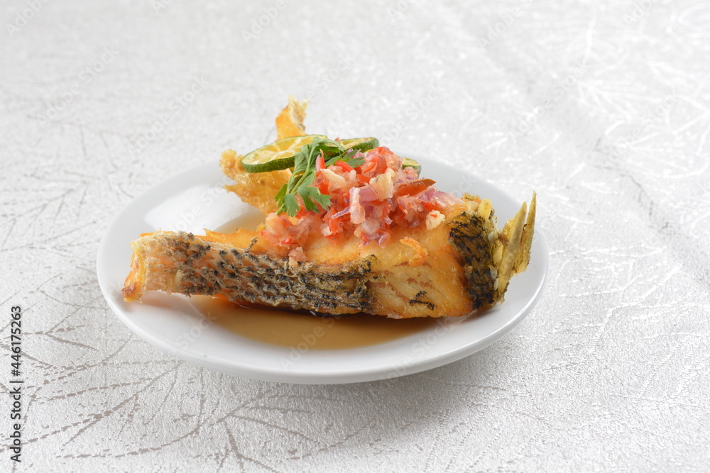 deep fried fresh grouper fish fillet in spicy and sour chilli lime ...