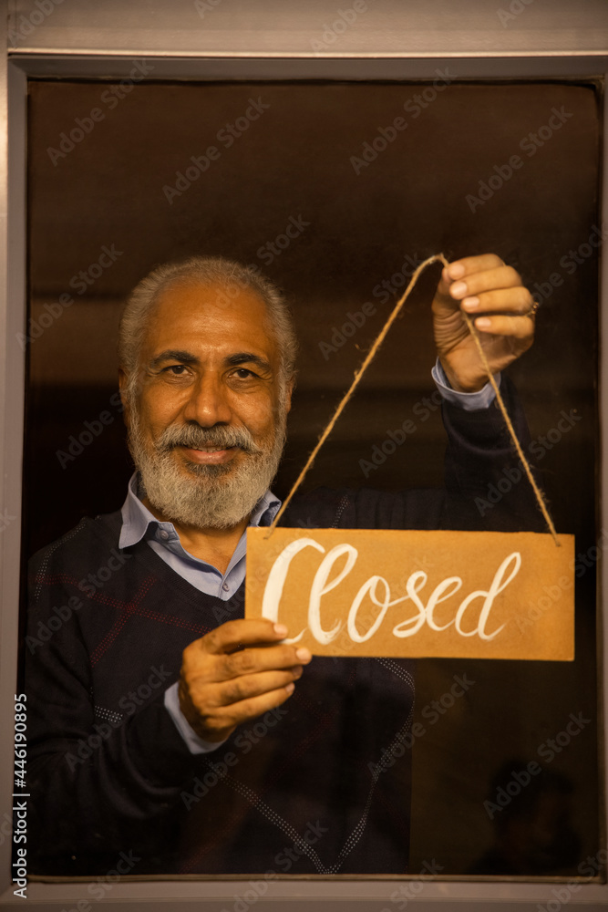 AN OLD MAN HOLDING CLOSED SIGN BOARD Stock Photo | Adobe Stock