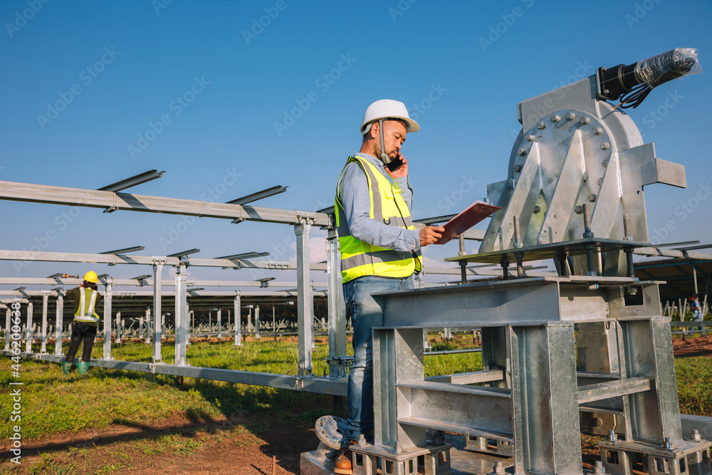 engineer inspect solar tracking machine in solar power plant; Monitor ...