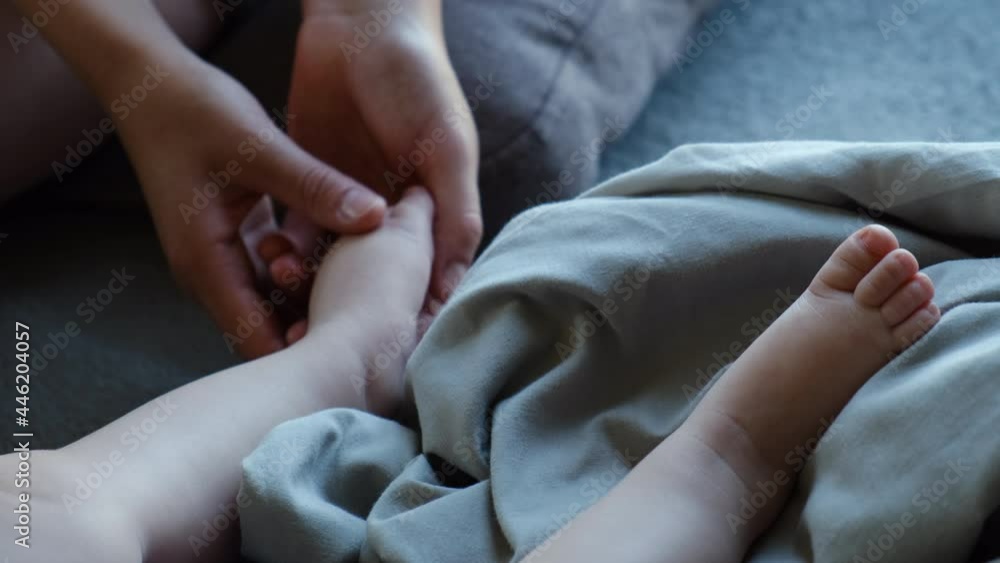 Close up of mother hand stroking child foot sweet baby dream baby foot ...