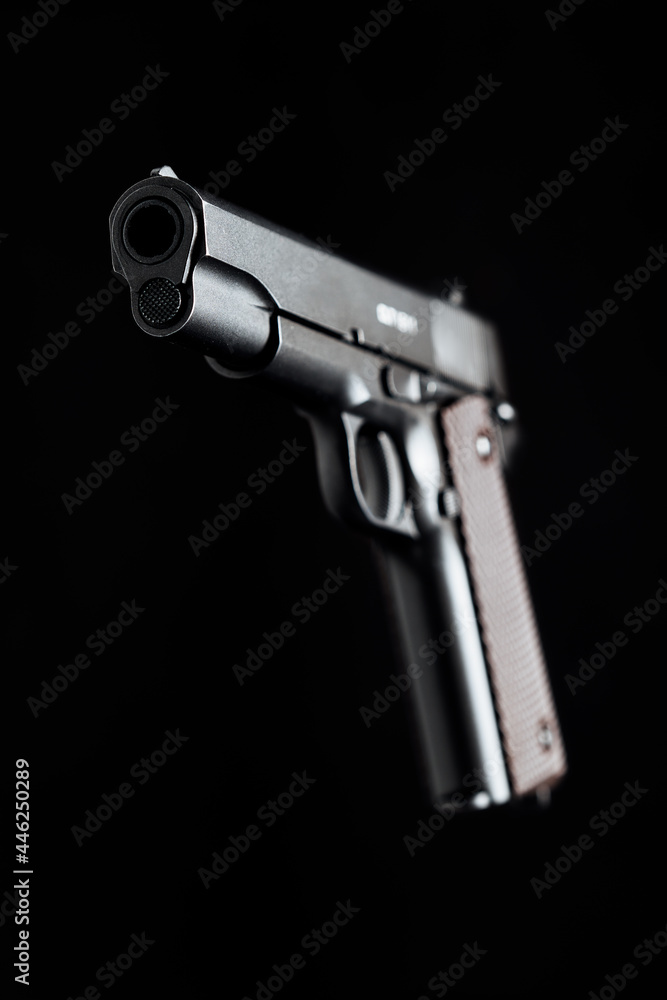 Colt 1911 pistol on the black background. Stock Photo | Adobe Stock