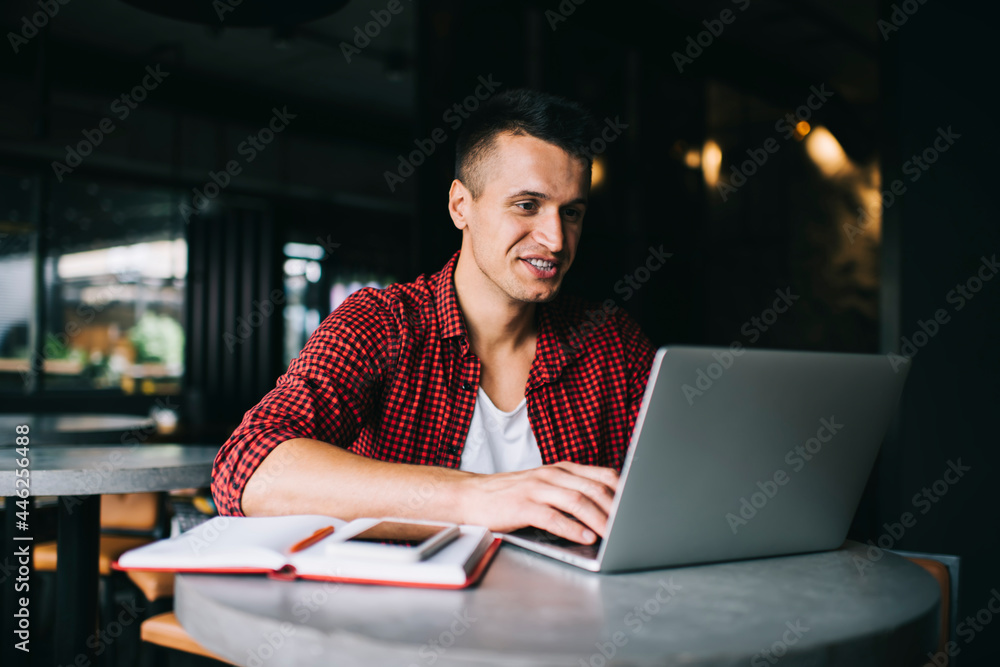 Skilled male copywriter with education textbook watching informative ...