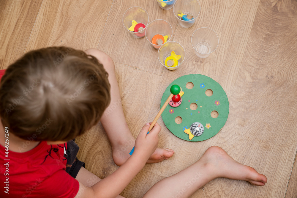 Let's go fishing. Wooden fishes and fishing rod with magnet on the tip ...