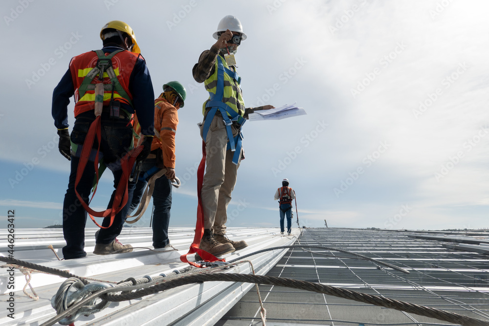 Construction worker wearing PPE woking at roof Stock Photo | Adobe Stock