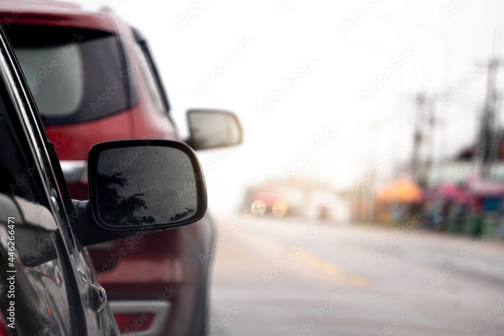 Abstract and blurred beside of car view on mirror wing. Parked in line ...