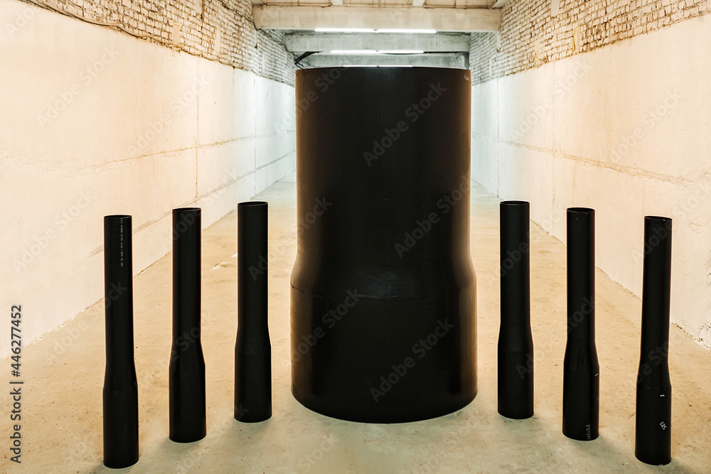black cylindrical plastic pipes of different diameters are in stock ...