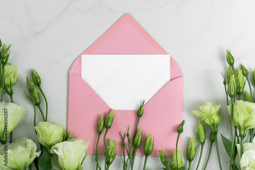 Real photo. Pink envelope square invitation card mockup with a eustoma ...