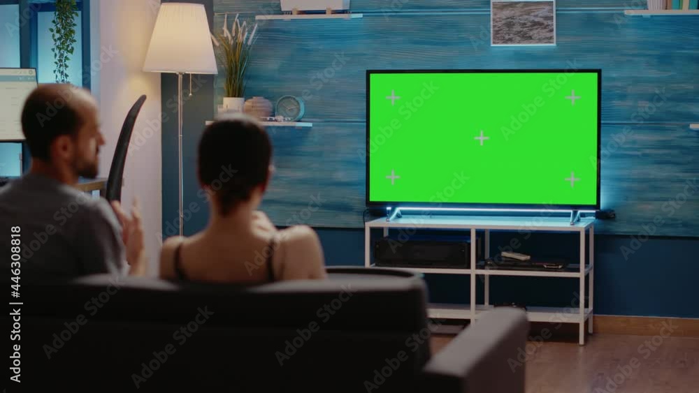 Green screen on television at home in living room used by young man and ...