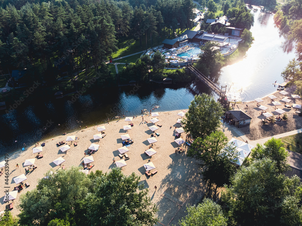Aerial top view of river sand beach with hotel cabins and pool. Local ...