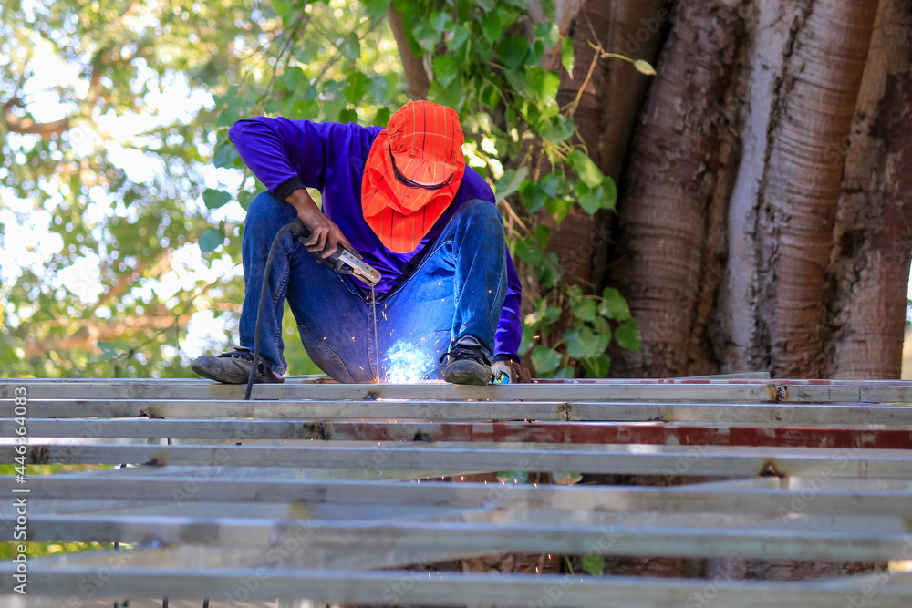 Welding the roof truss.welders working at dangerous heights. Welding of ...