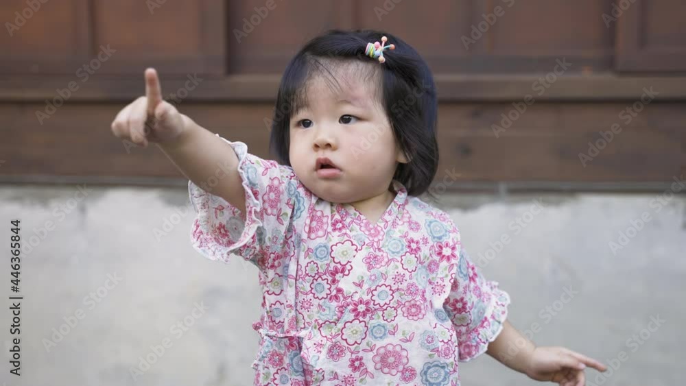 lovely japanese toddler girl wearing kimono and playing outside is ...