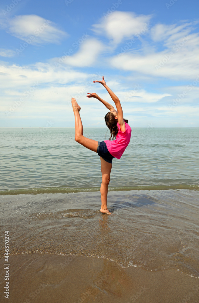 girl doing rhythmic gymnastics exercises on the beach Stock Photo ...