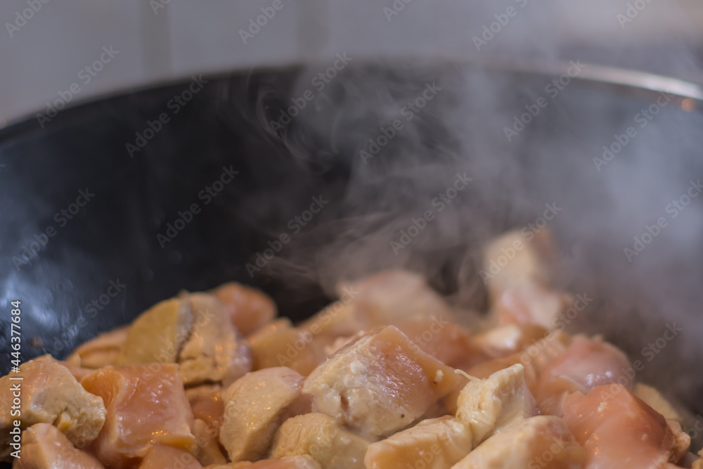 smoking cut meat while cooking Stock Photo | Adobe Stock
