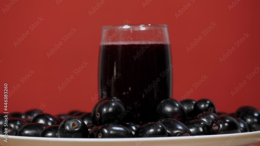 A few Indian blackberries falling on a heap of fruits kept together on ...