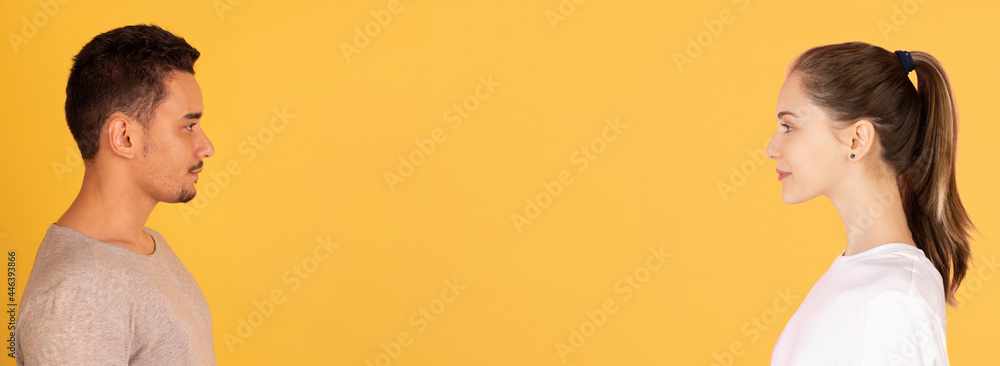 Portraits of two people, man and woman standing opposite each isolated ...