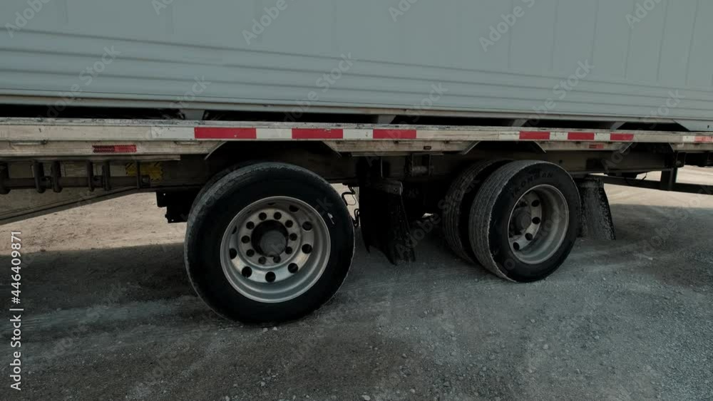 Truck driver, adjusts the distance between the axles for the correct ...