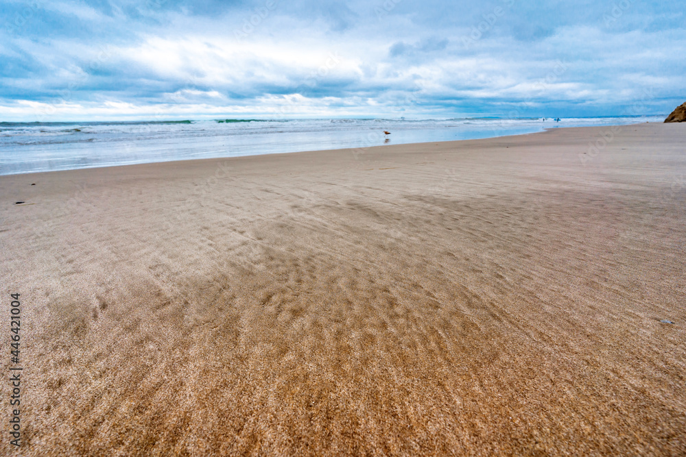 Striped sand on a California beach. Golden sand with an admixture of ...