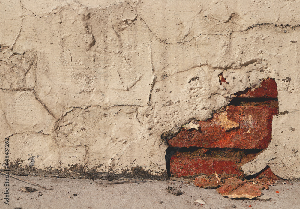 Details of crumbling dilapidated facade wall of an old house. Red brick ...