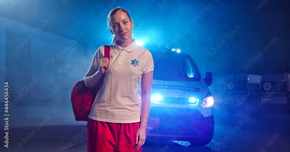 Caucasian blonde young female paramedic in uniform getting ready to ...