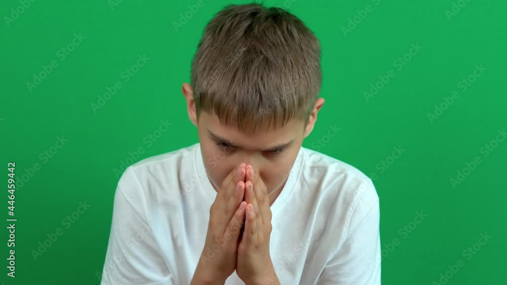 Worried nervous teenage boy sitting and thinking, begging, praying over ...