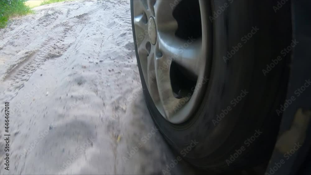 Filming of a car driving off-road. The camera shoots the wheel, taking ...
