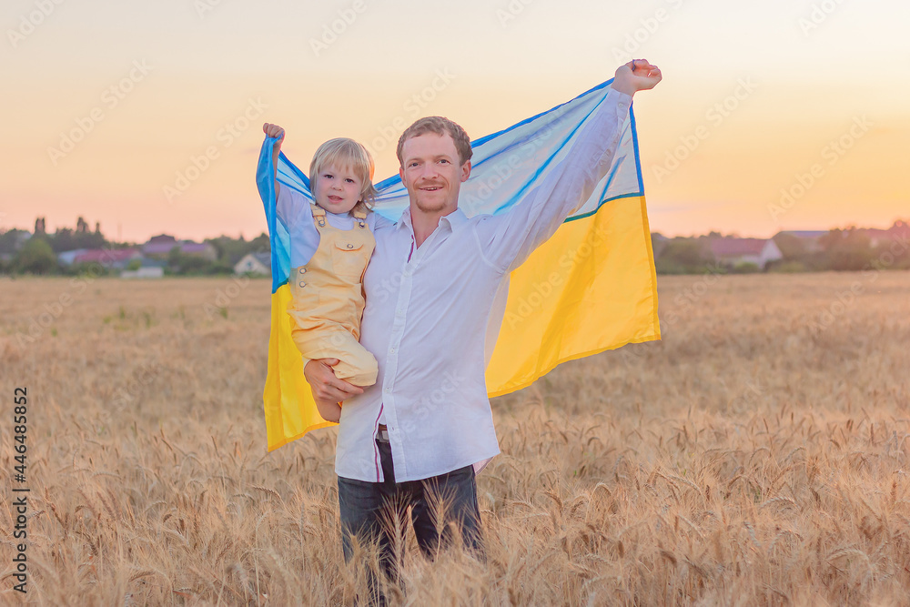 man and child boy with the national flag of ukraine. father and son ...