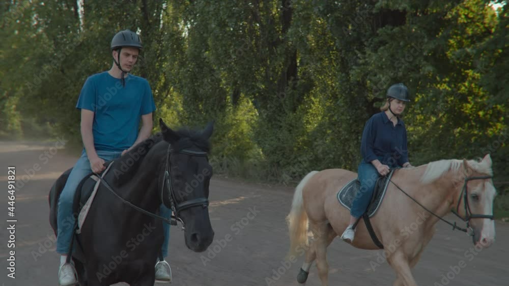 Man and woman riding horses together. Couple learning to ride horse ...