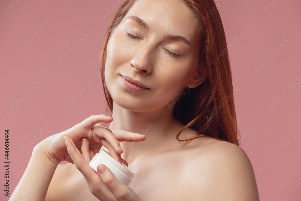 Portrait of young female fashion model isolated on prink studio ...