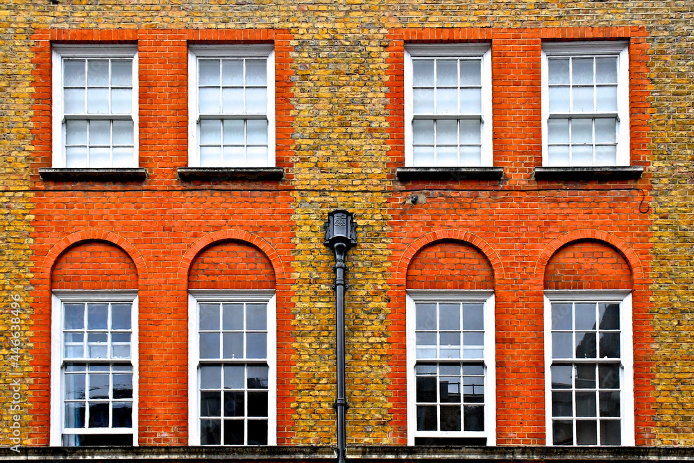 Brick Wall of the iconic London Stock bricks, Windows and a soil pipe ...
