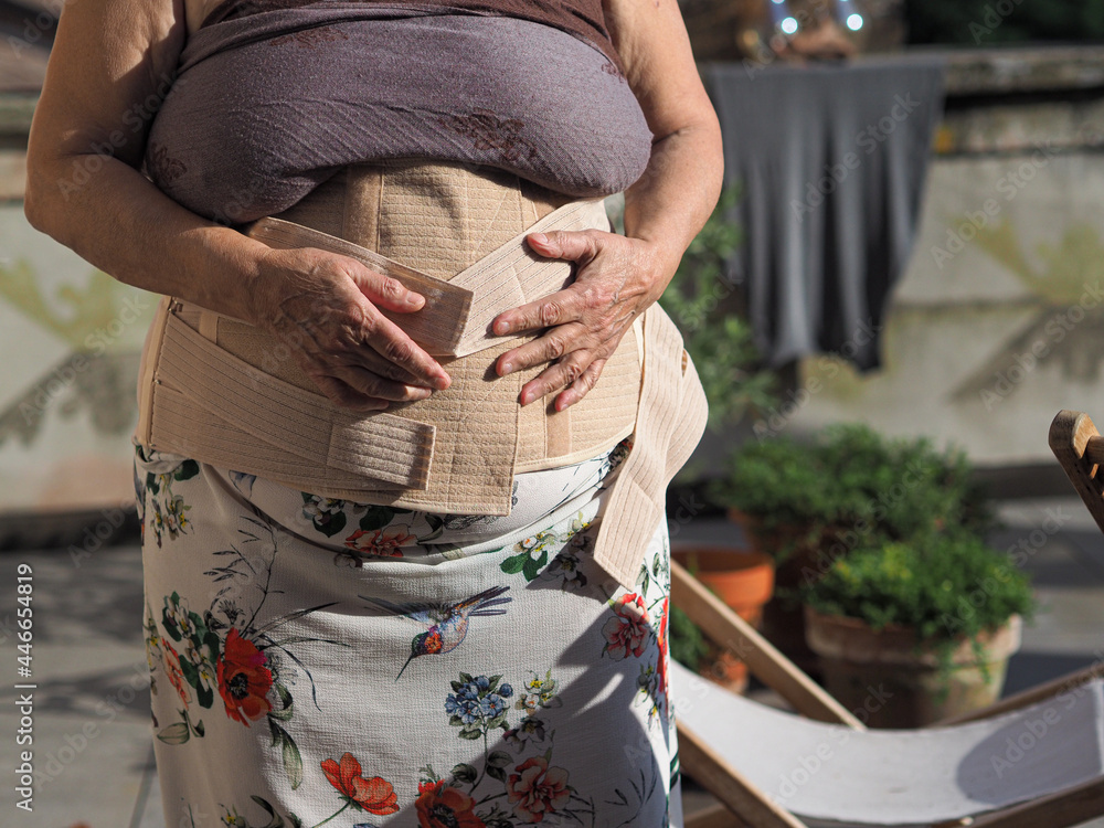 Shallow focus of a lady wearing a semi-rigid thoracic lumbosacral ...