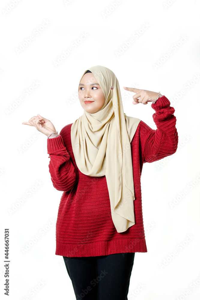Asian muslim woman pointing her finger on isolated white background ...