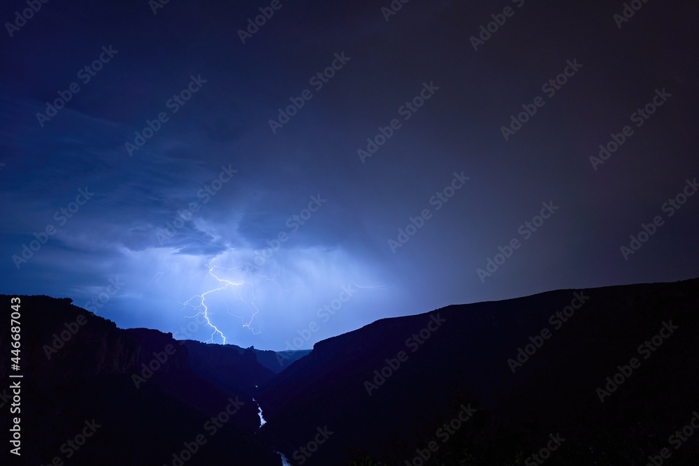Nocturnal thunderstorm with lightning that makes the river Tarn and the ...