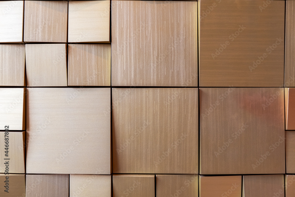 square silver tiles of different sizes on the wall. rough surface ...