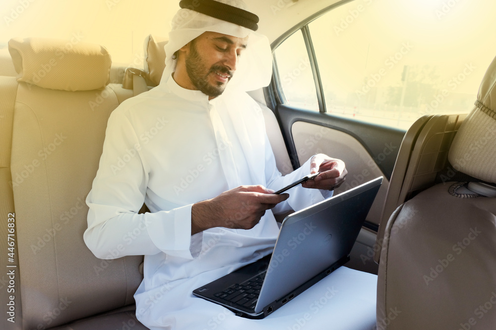 Middle Eastern Emirati Man using laptop computer ideal for business and ...