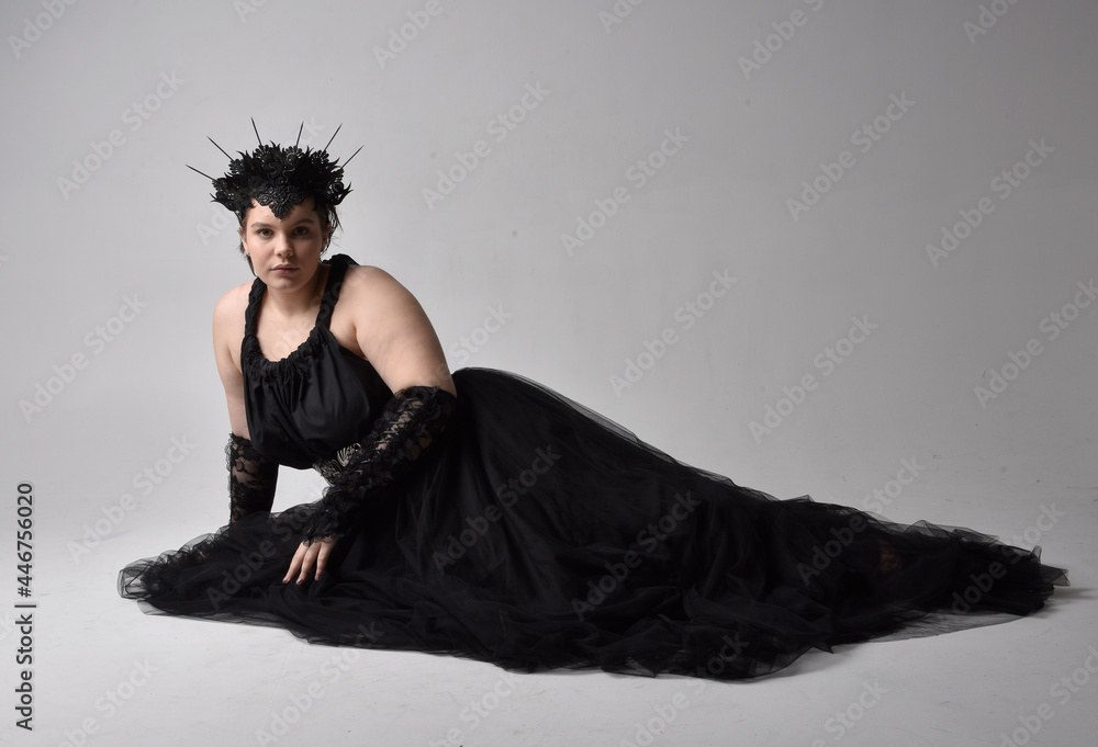 Full length portrait of young plus sized woman with short hair, wearing ...