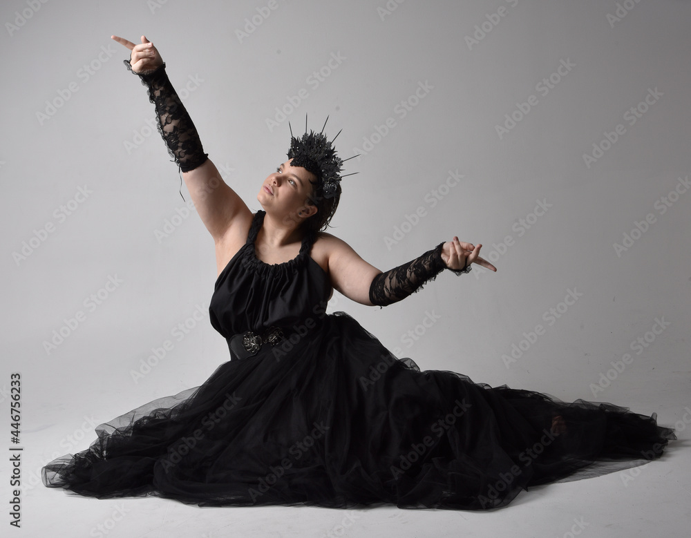 Full length portrait of young plus sized woman with short hair, wearing ...