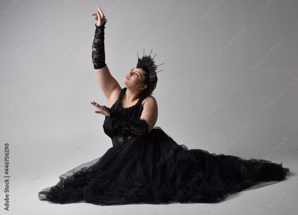 Full length portrait of young plus sized woman with short hair, wearing ...